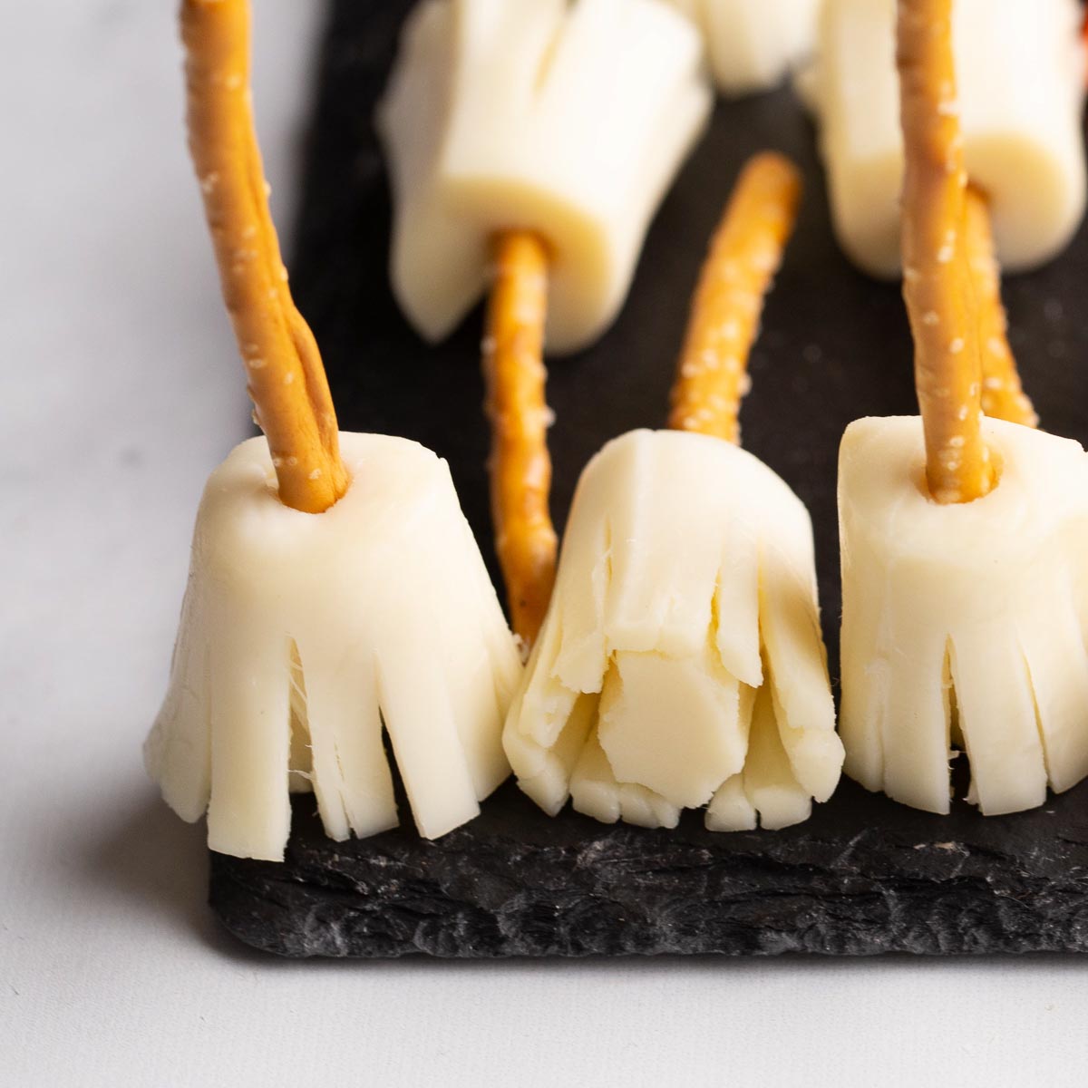 String Cheese Pretzel Broomsticks